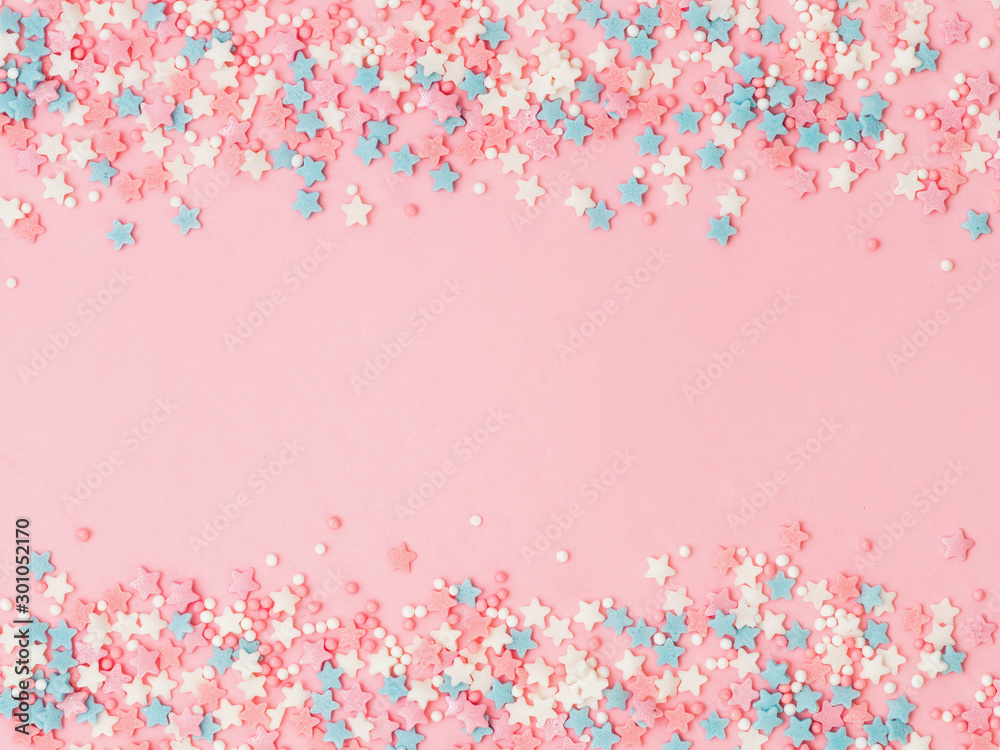 Festive border frame of colorful pastel sprinkles on pink background ...
