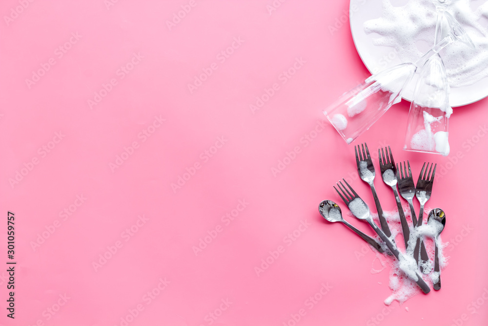 Washing dishes concept. Plates, spoons, forks on pink background top ...