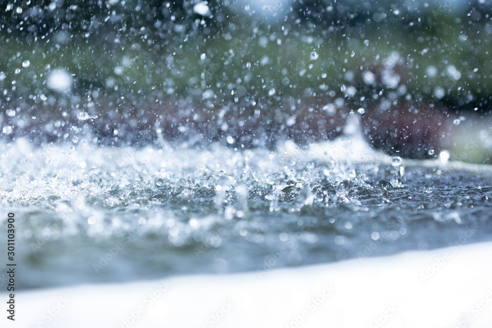 blue color tone of close up rain water drop falling to the floor in ...