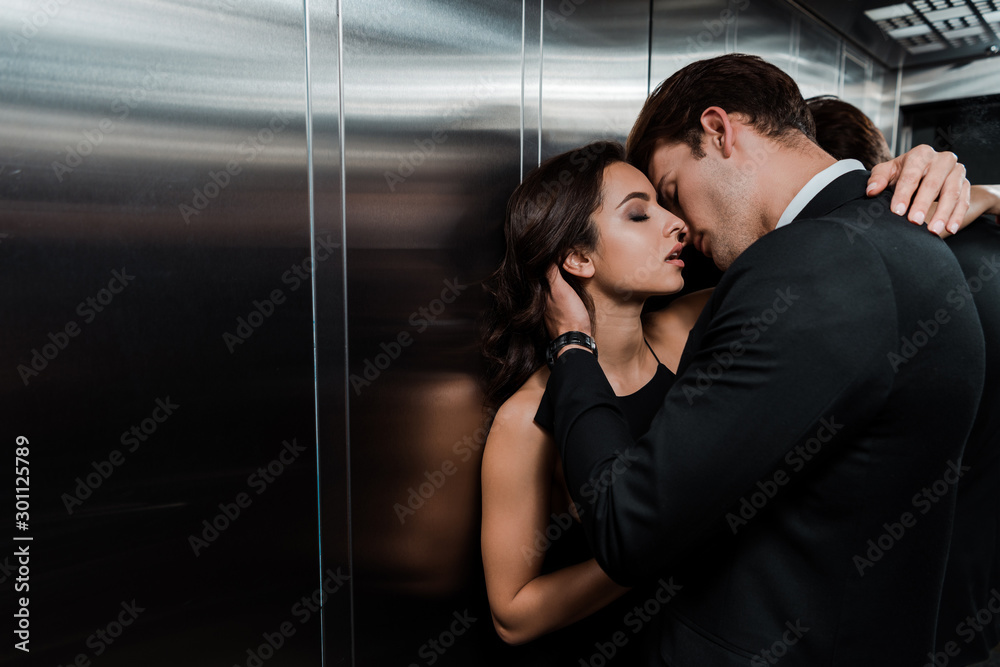 beautiful passionate couple hugging and going to kiss in lift Stock ...