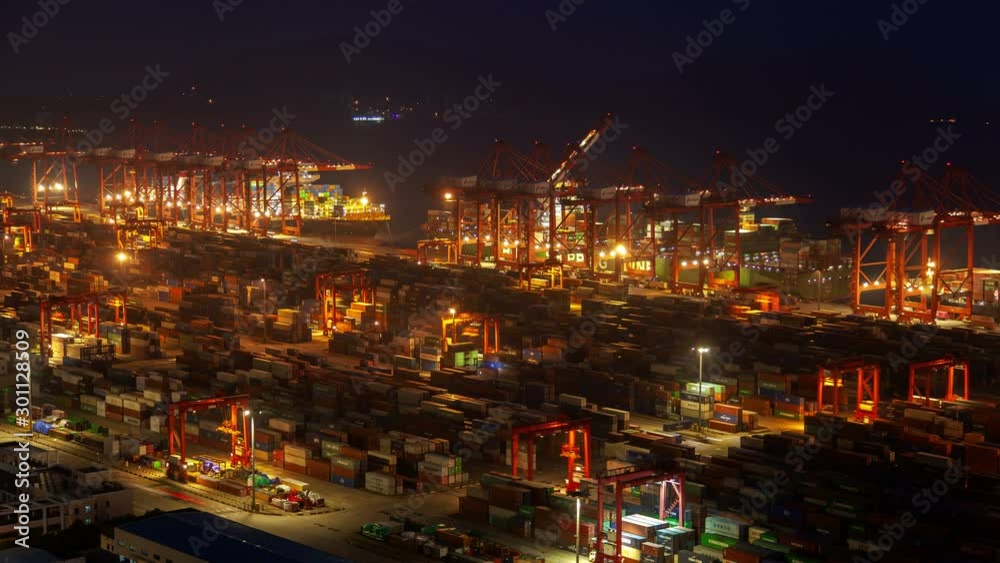Timelapse illuminated Shanghai cranes load large cargo vessels in ...