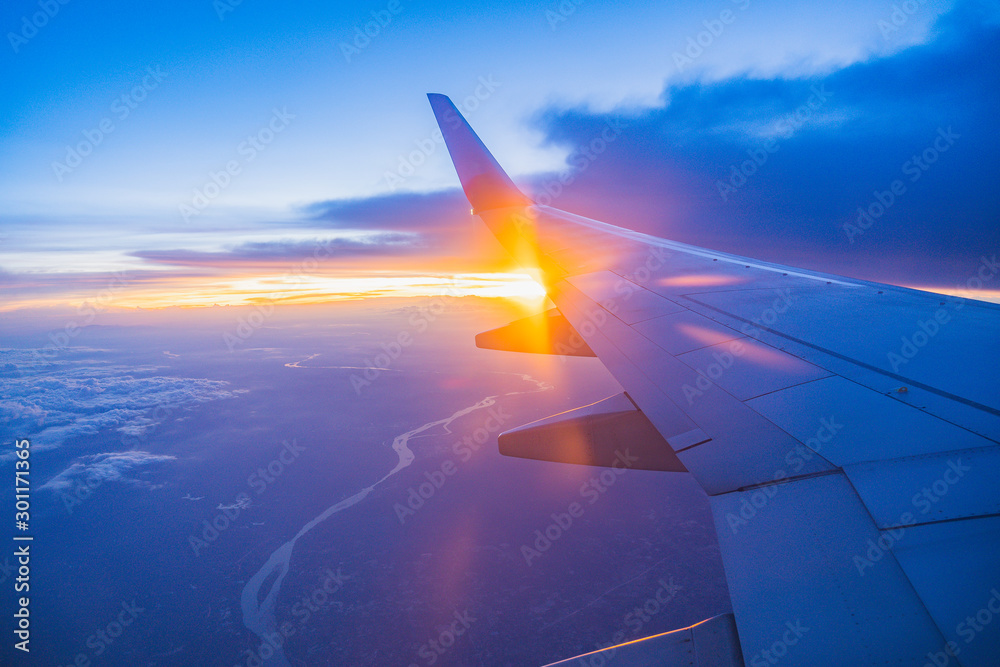 Beautiful sunset, sky on the top view, airplane flying view from inside ...