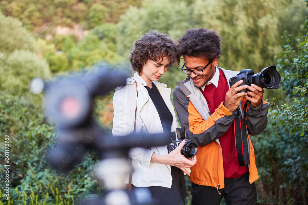Photographer team in nature at the camera comparison Stock Photo ...