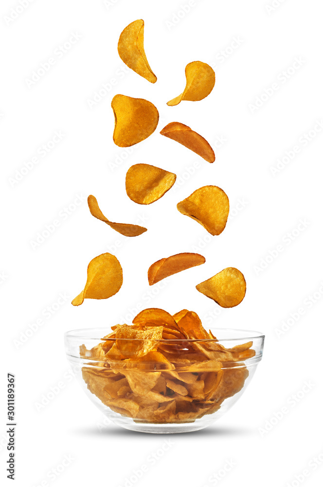 Potato crisps falling down in glass bowl, isolated on white background ...