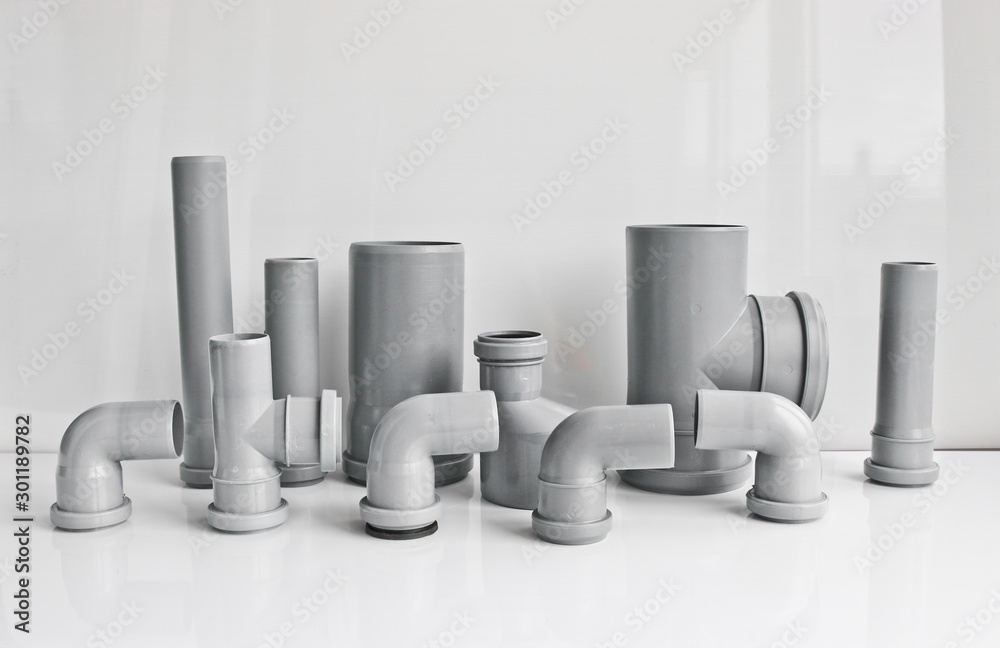 Plastic PVC pipes sewer fittings on a light background. Stock Photo ...