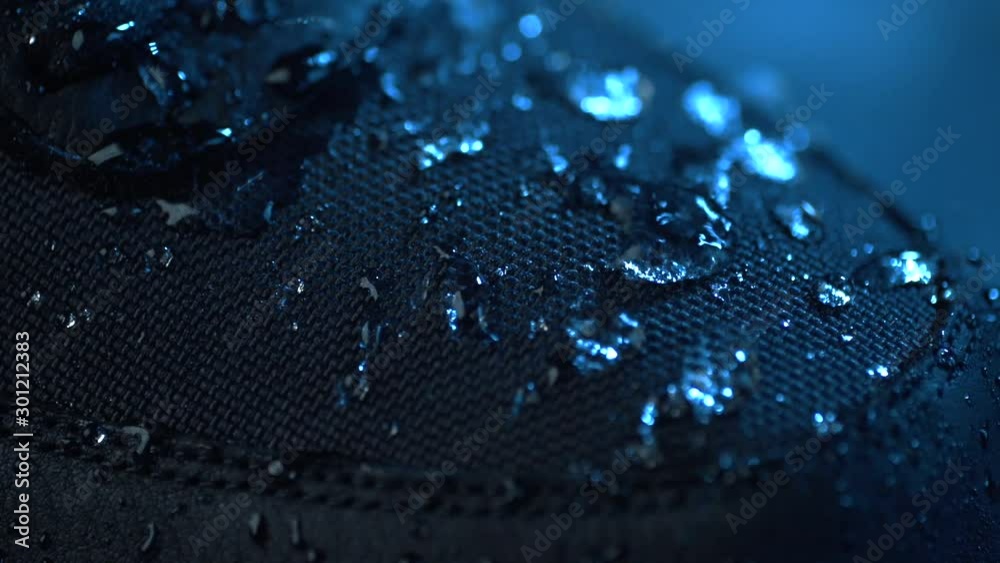 Water drops on waterproof membrane fabric of shoes surface, macro shot ...