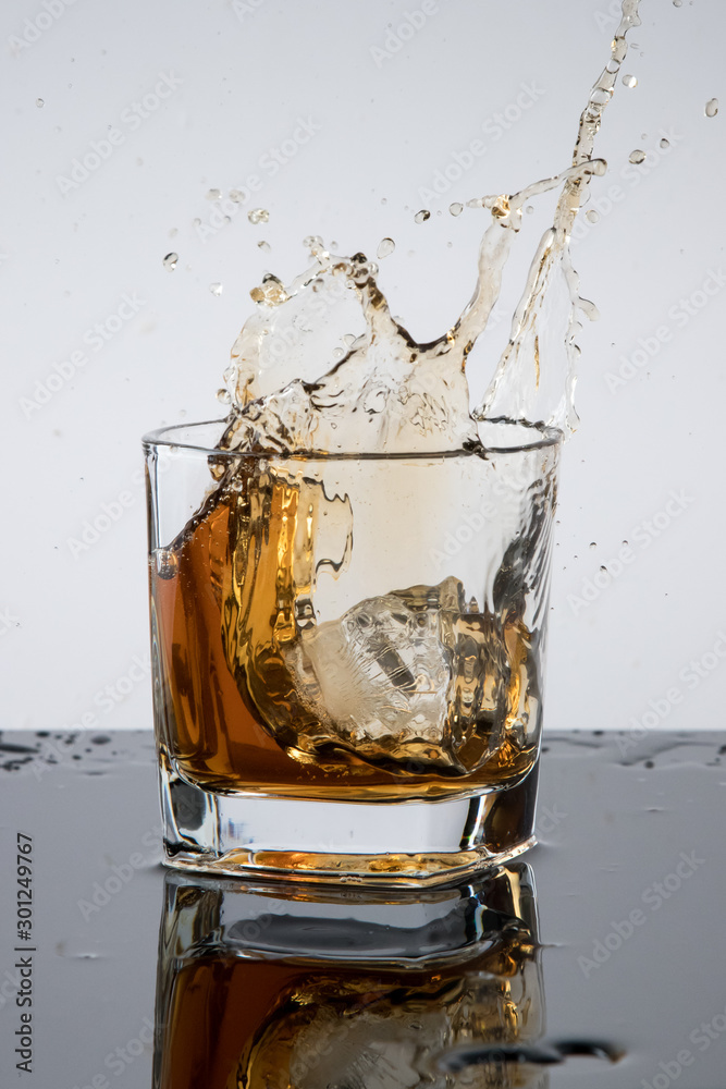 a glass of whiskey, drops, spray, splash of fluid, a stop time, after a ...