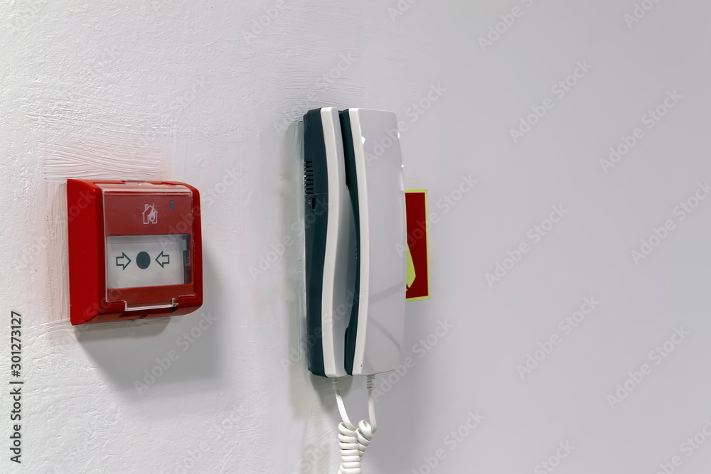 Wall mounted Red fire alarm button used to activate warning systems in ...