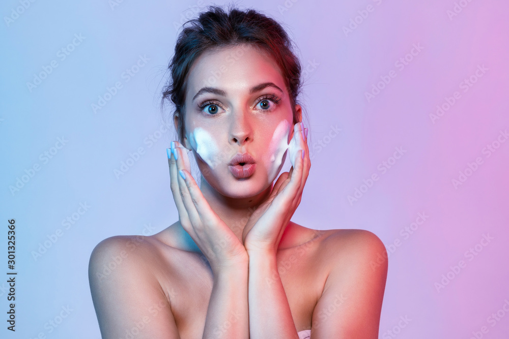 Portrait of beautiful woman looking at camera with surprising ...