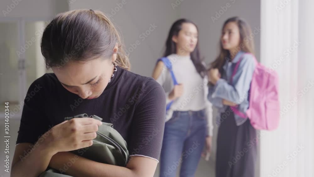 Sad high school student bullied or mocked by her friends at school ...