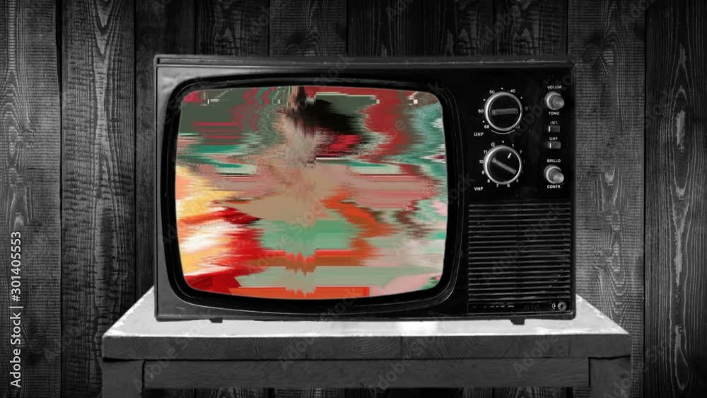Zoom in then fixed shot on 70s television, color deformations, static ...