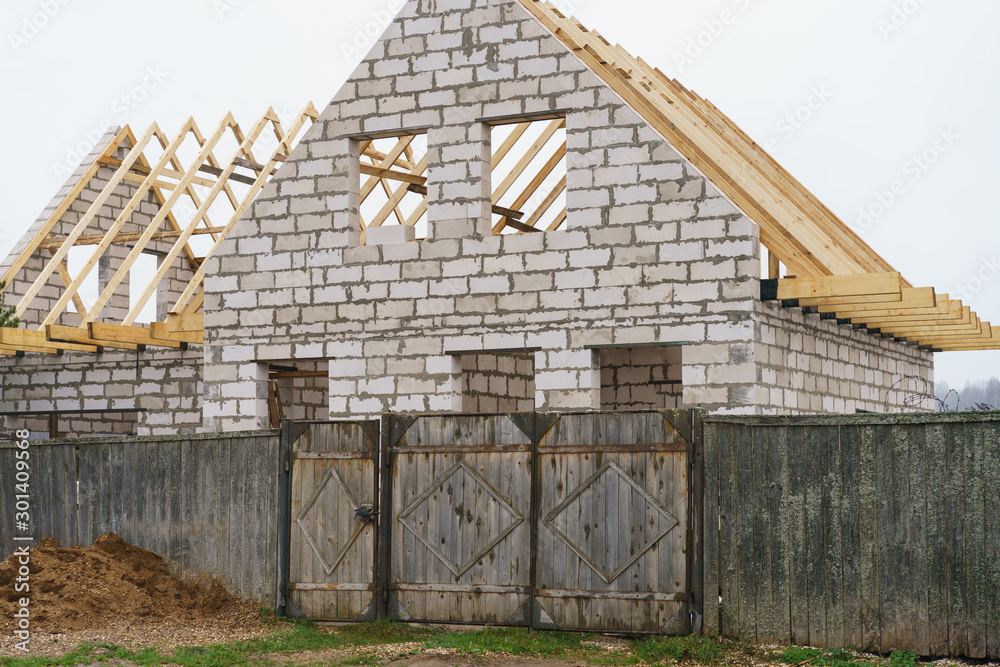 Unfinished house in countryside. Part of house with wooden construction ...
