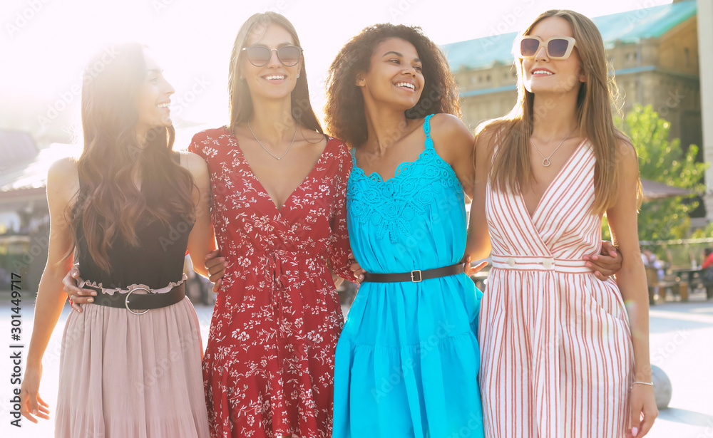 Happy together. A group of four young girls are posing together in the ...