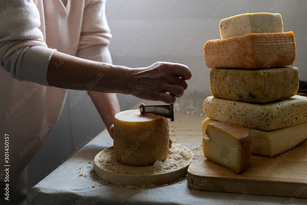 Scraping Device of Swiss Cheese Tete de moine. A man cuts cheese. Stock ...
