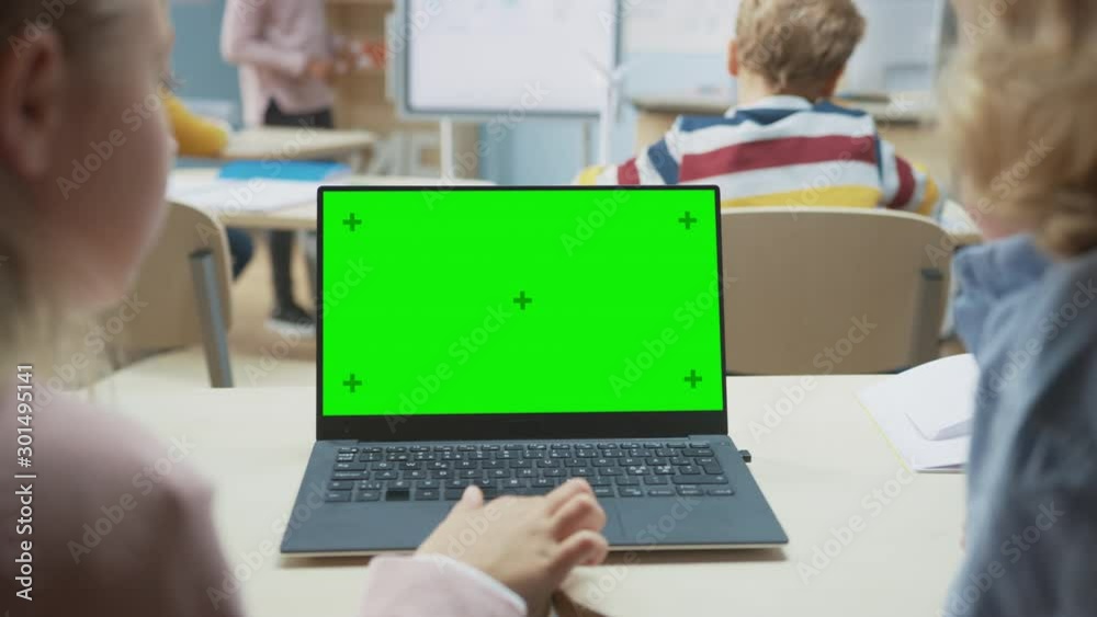 Elementary School Classroom: Over the Shoulder View of a Two Kids Using ...