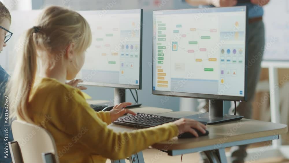 Elementary School Computer Science Classroom: Cute Little Girl Uses ...