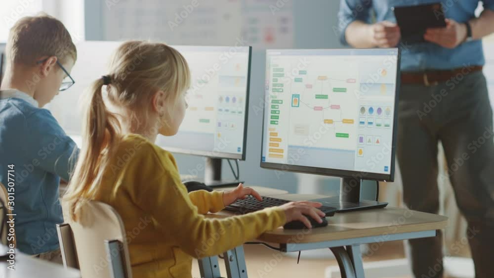 Elementary School Computer Science Classroom: Cute Little Girl Uses ...
