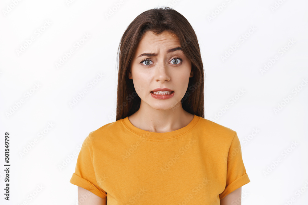 Awkward and worried cute embarrassed woman apologizing, cringe and ...