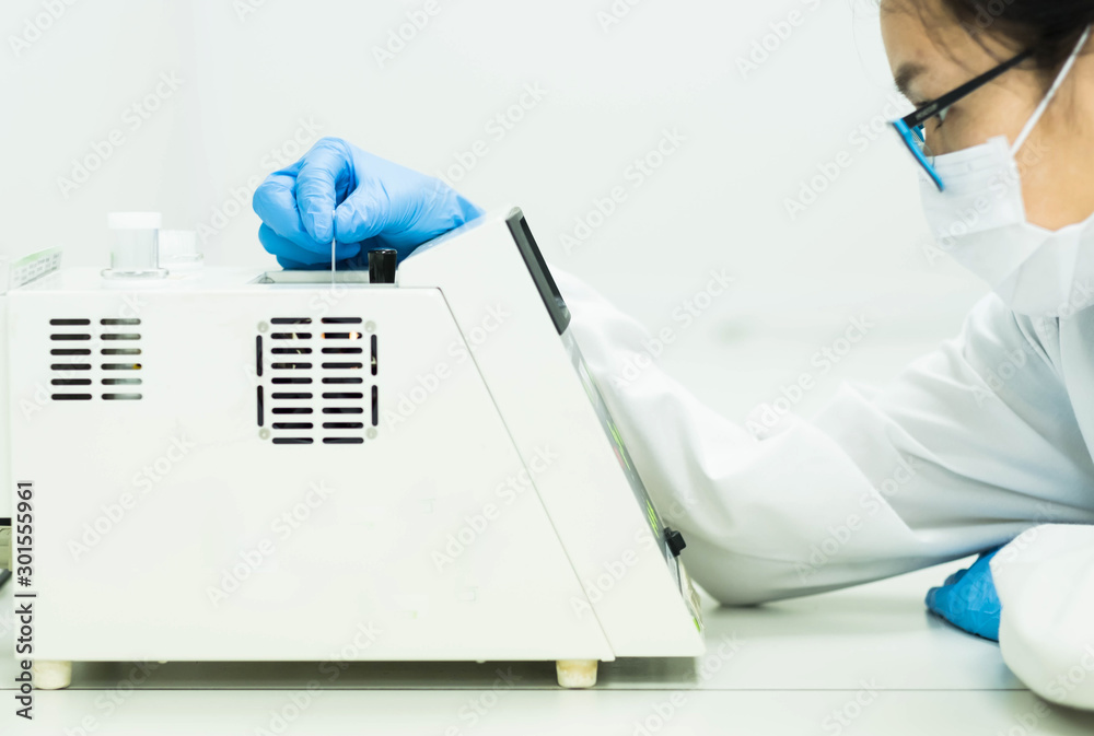 Chemist is insert capillary tube to melting point testing equipment in ...