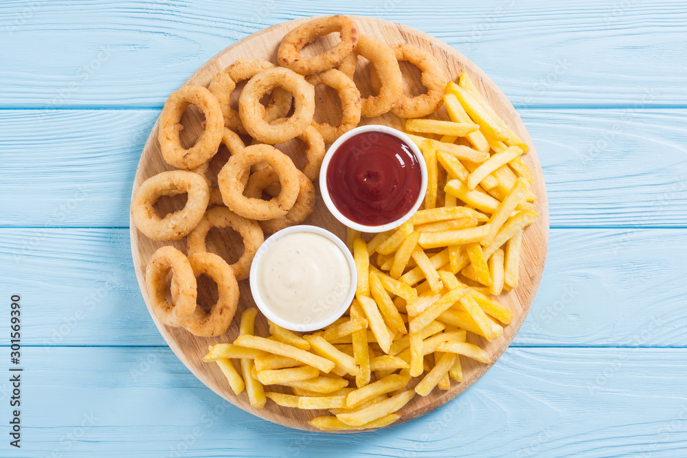French fries and onion rings with sauces Stock Photo | Adobe Stock