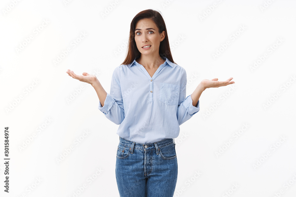 Uncomfortable awkward adult female coworker shrugging, clench teeth ...
