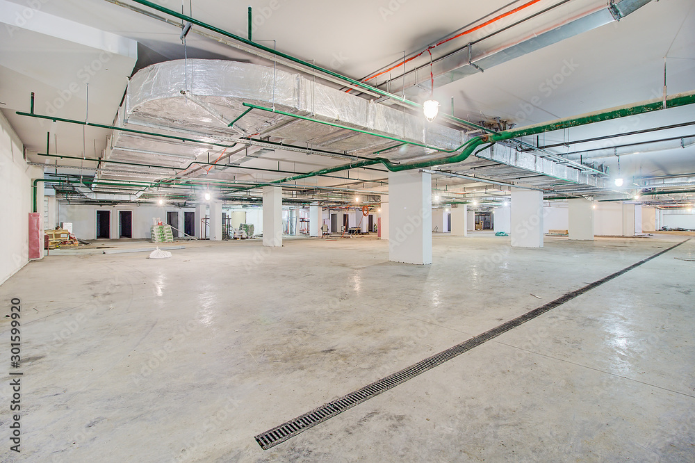 Underground parking in construction phase. Empty garage in basement of ...