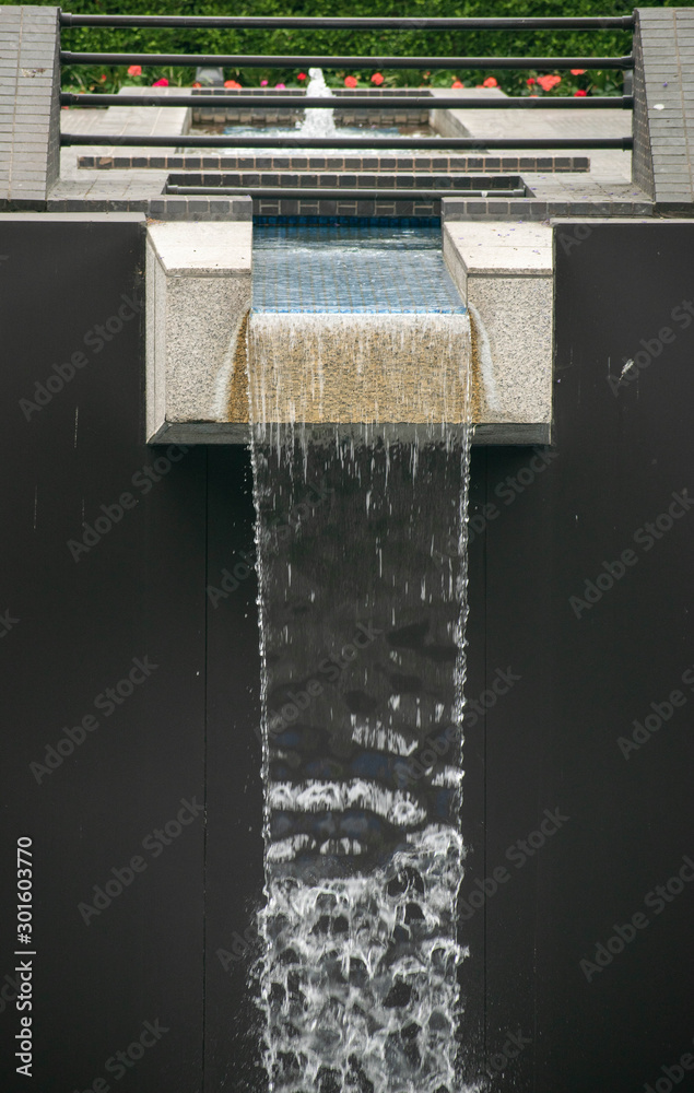 Water flows over rock and brick structure Stock Photo | Adobe Stock