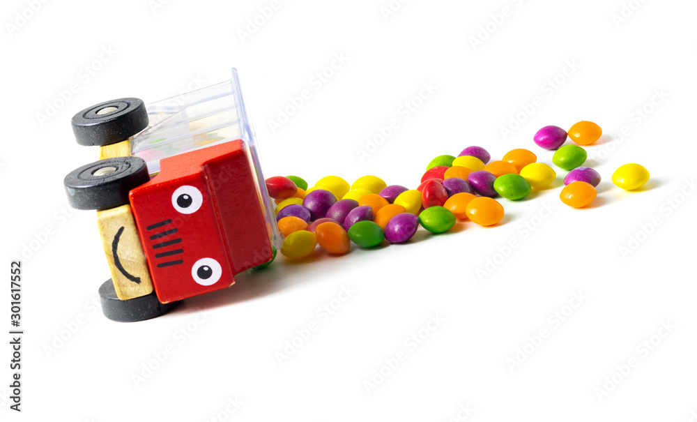 multi-colored candies fell from the back of a red children's toy car ...