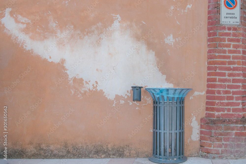 Trash can on a brick wall Stock Photo | Adobe Stock