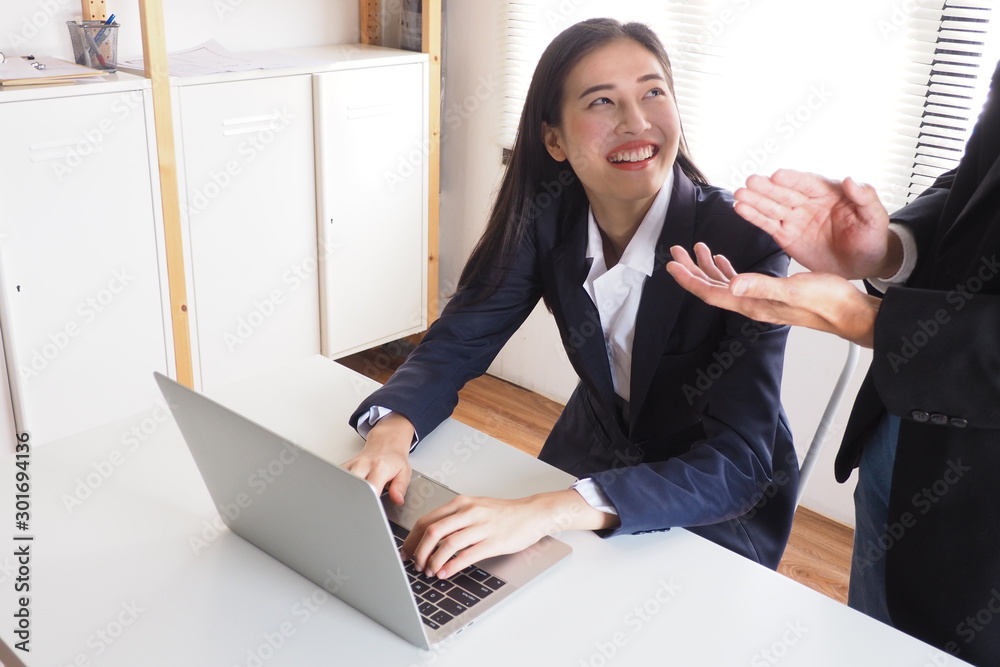 Male manager standing and clapping to show approval to his female ...