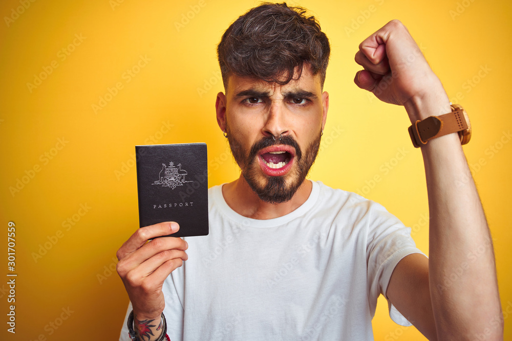 Young man with tattoo wearing Australia Australian passport over ...