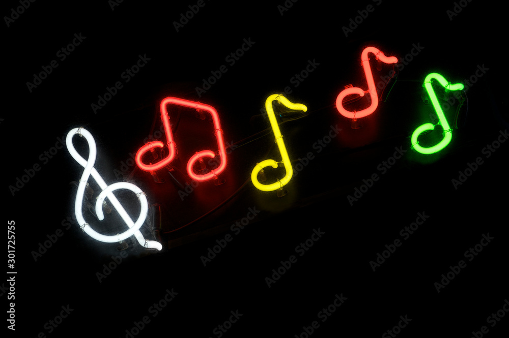 Musical notes with treble clef in colorful neon lights floating across ...