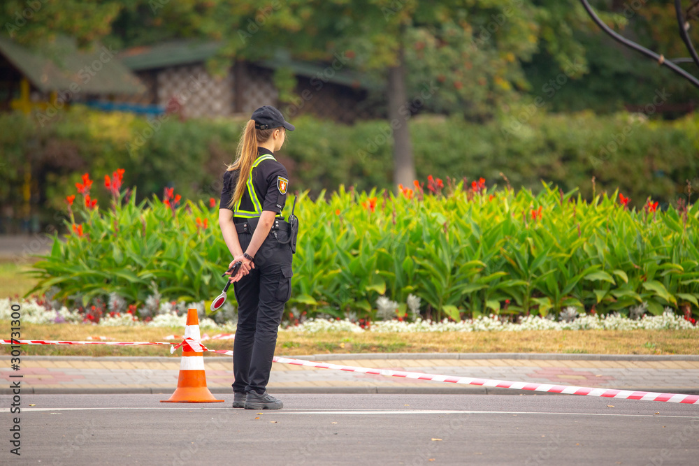 Police woman against closed road due to accident and red with white ...