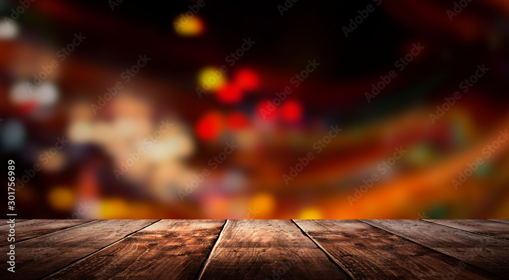 Wooden table, blurred bokeh background background. Neon light, night ...