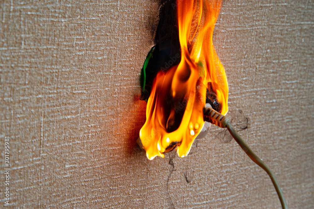 Defective wiring causes a fire. Burning electrical wiring and socket ...