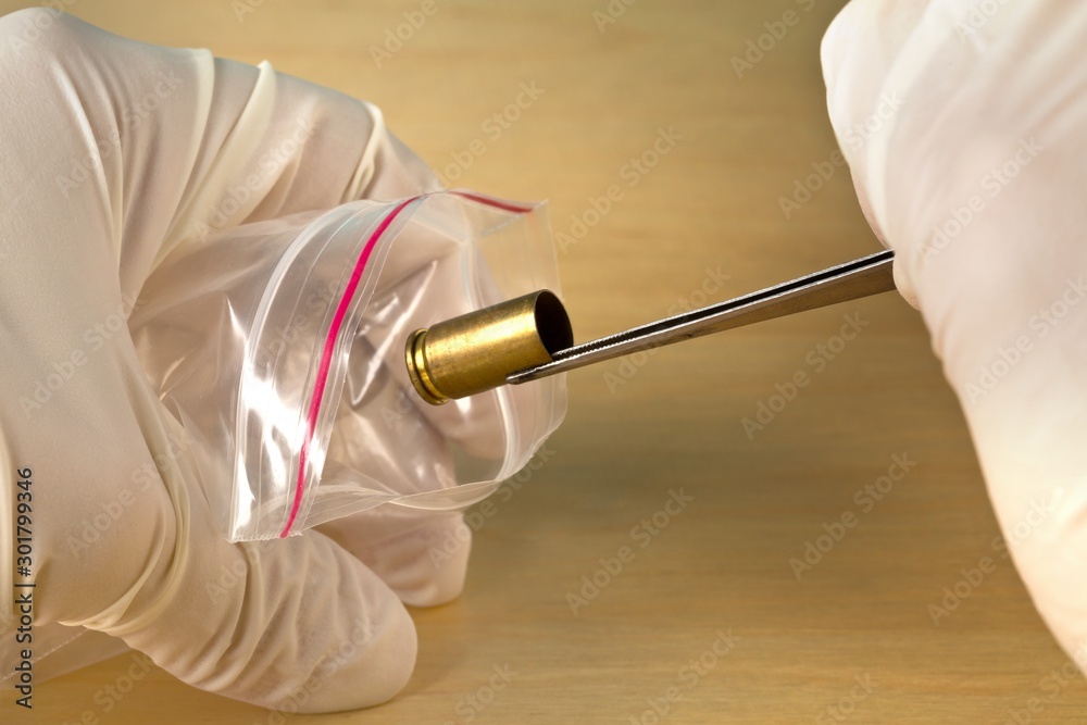 Crime scene investigation CSI forensic collecting bullet casing ...