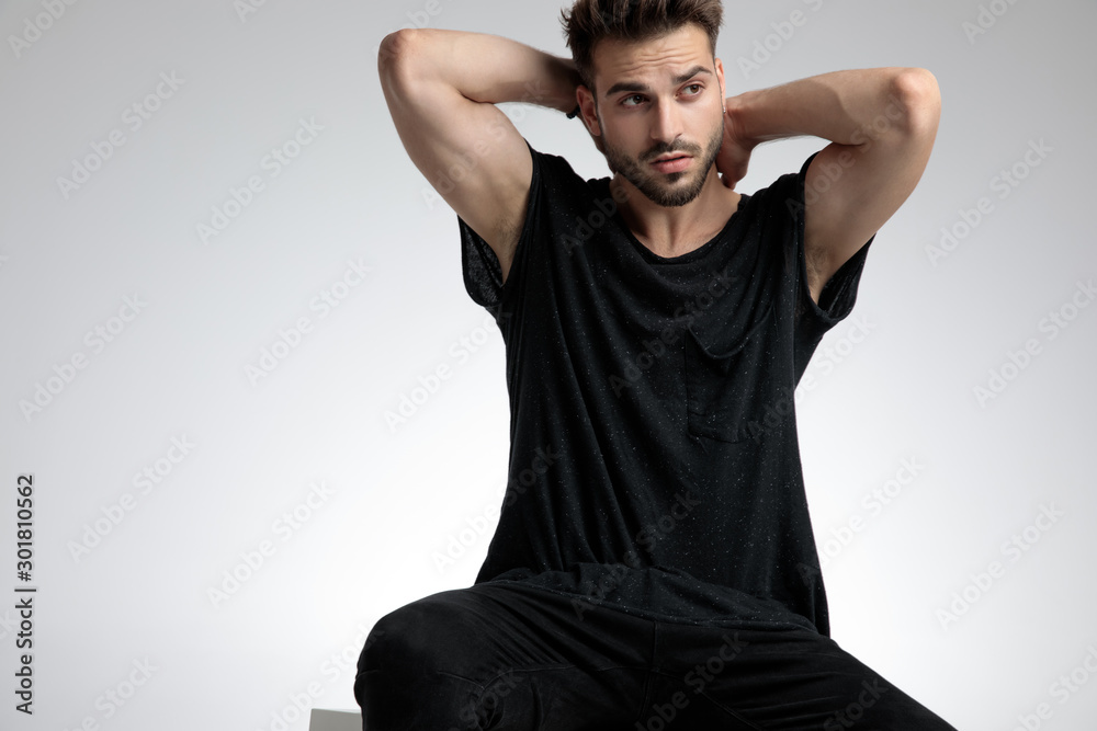 sexy fashion guy holding hands behind neck and posing Stock Photo ...