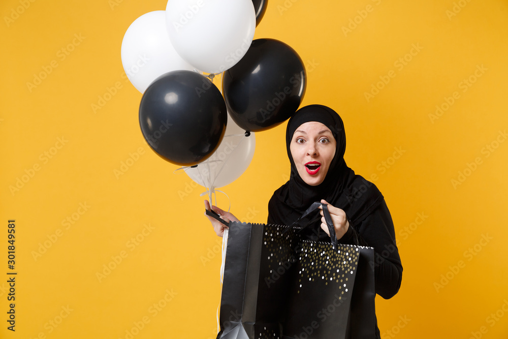 Arabian muslim woman in hijab celebrating holding black white air ...