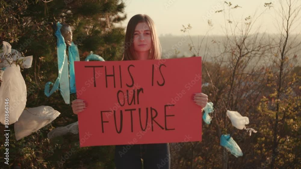 Slow motion woman activist holding encouraging red poster This is our ...