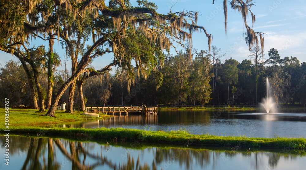 Dock and fountain at a central Florida lake. Stock Photo | Adobe Stock