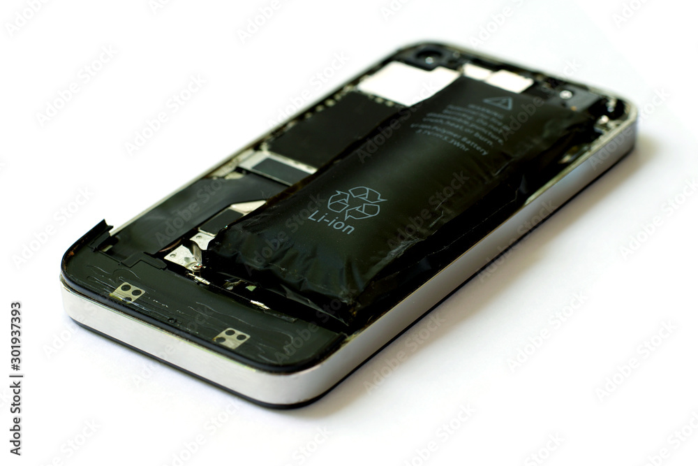 Swollen lithium ion polymer battery inside a mobile phone on white ...