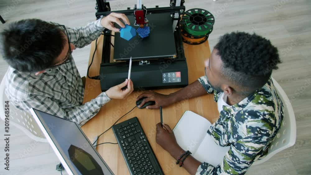 High angle view of smart guys making 3d model with three dimensional ...