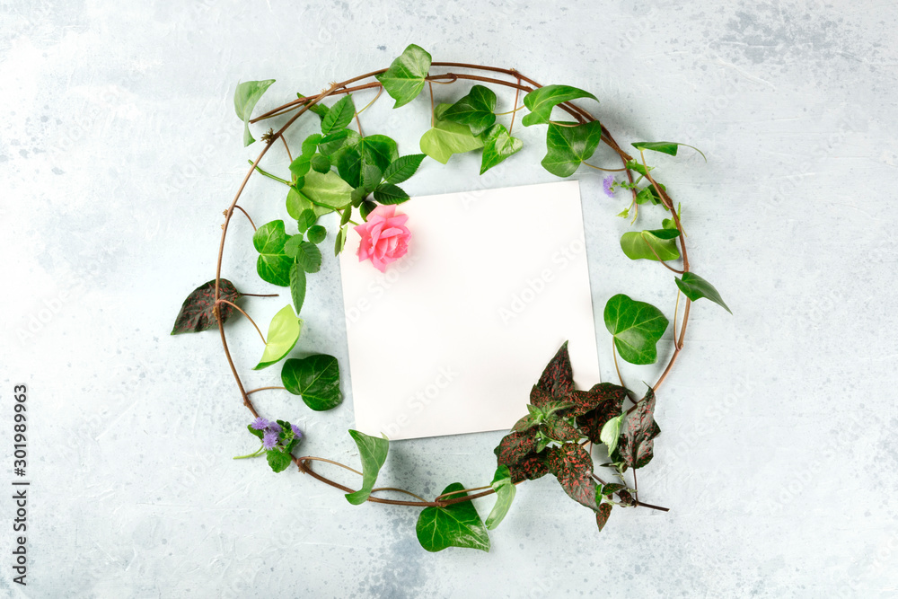 Invitation or greeting card design template with a flat lay wreath of ...