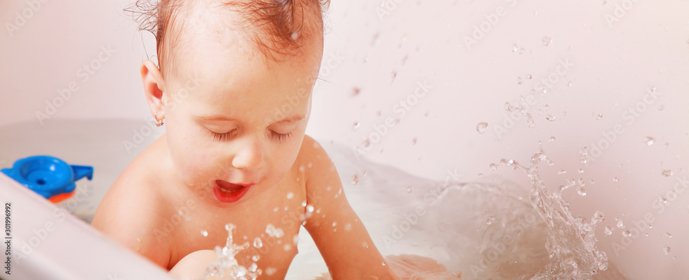 Funny portrait of beautiful little child girl bathing in the water in ...