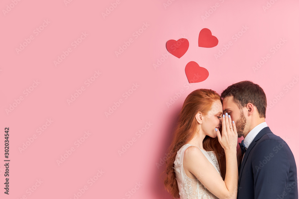 Side view on cute couple kissing, isolated over pink background. Woman ...