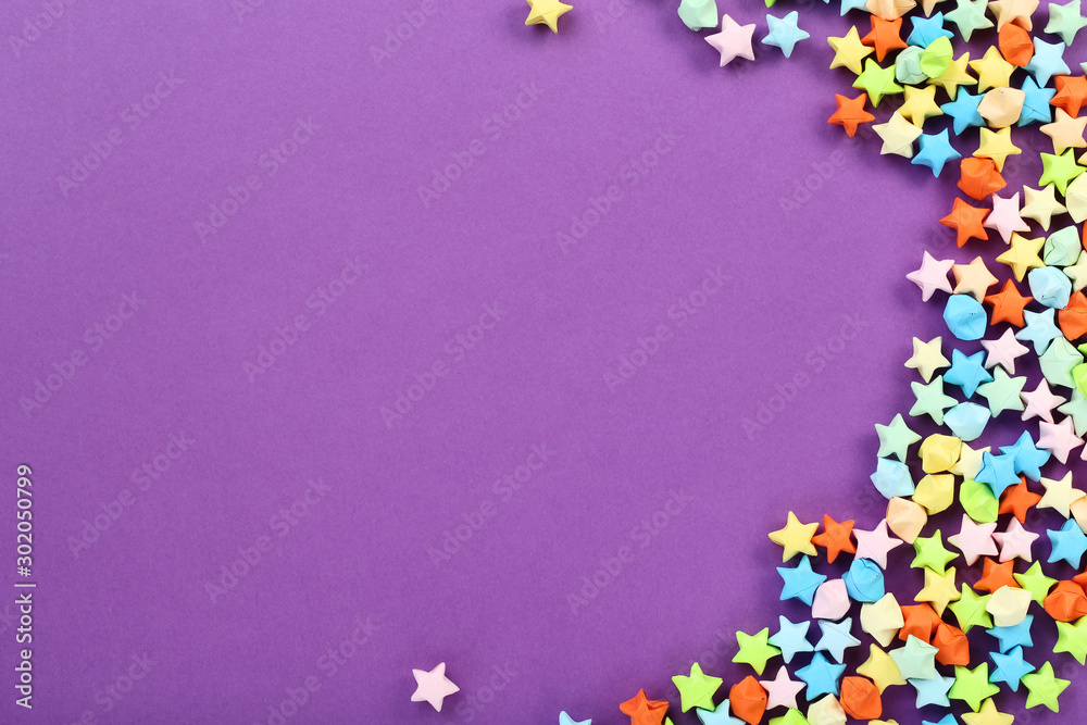 Colorful paper stars on purple background Stock Photo | Adobe Stock