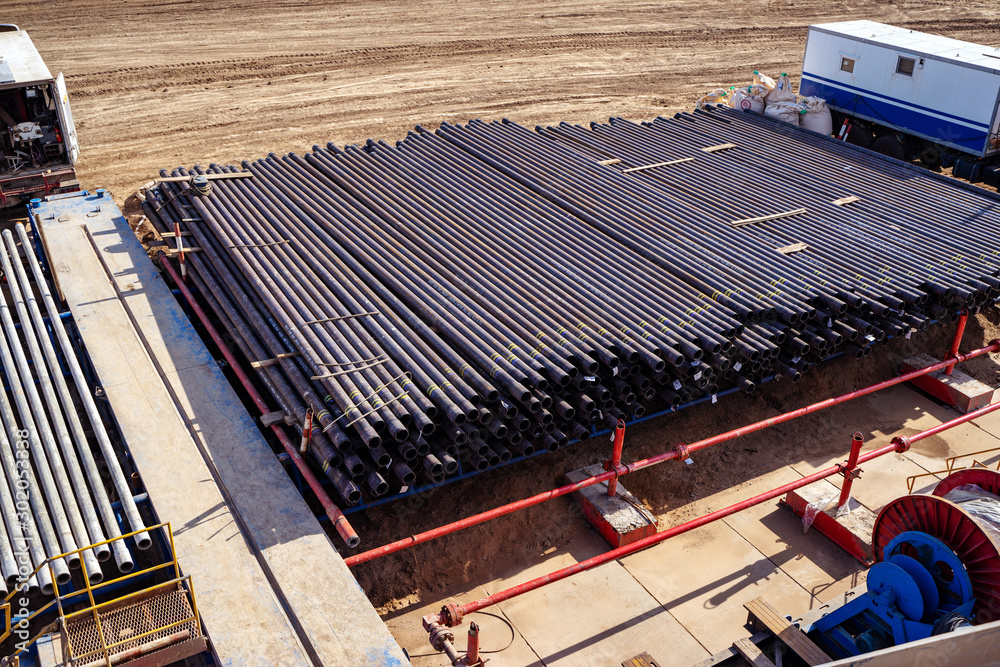Down view through Rig floor stairs to pipes on pipe rack next to ...