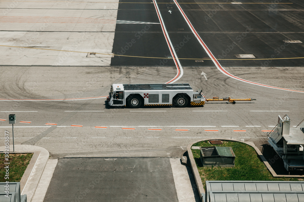 Airfield tractor rides on the road at the airport Stock Photo | Adobe Stock
