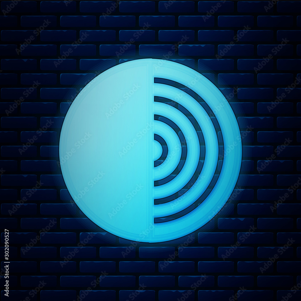 Glowing neon Earth structure icon isolated on brick wall background ...