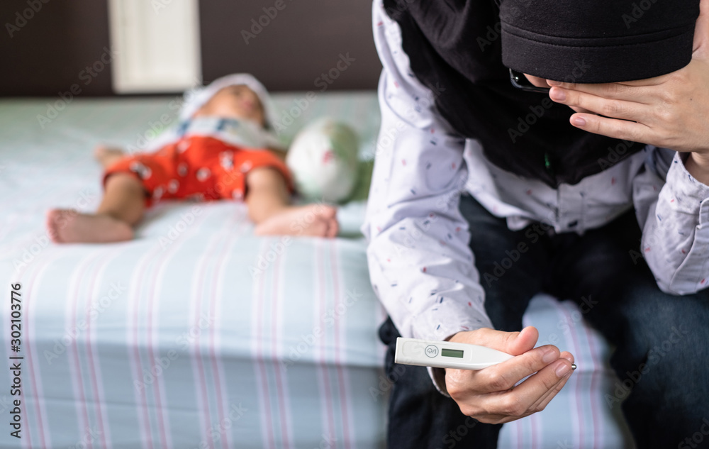 Stress and worried muslim mother wearing hijab with her son sickness ...